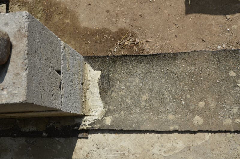 Laying Cinder Block on the Metal Corners in the Place of the Doorway ...