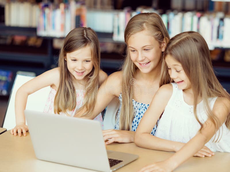 Technology in the library stock photo. Image of sisters - 56147668