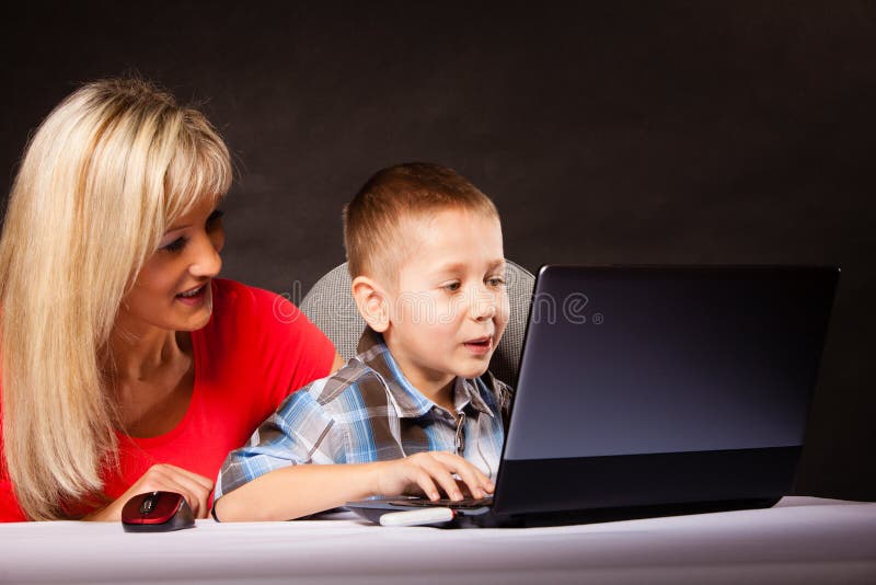 Technology and Parenting - Boy and Mother with Laptop Stock Photo ...