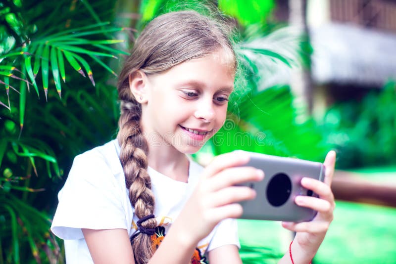 Technology and People Concept - Happy Smiling Girl Using Smartphone ...