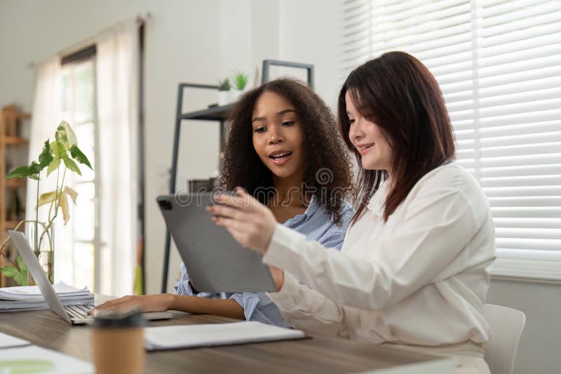 Technology and Team Collaboration. Two Colleagues Reviewing Information ...
