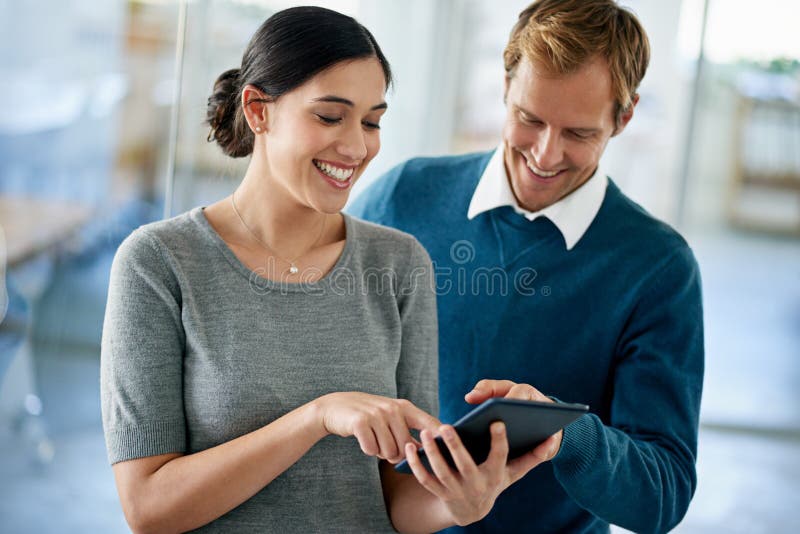 Technology is Their Third Team Mate. Two Colleagues Using a Digital ...