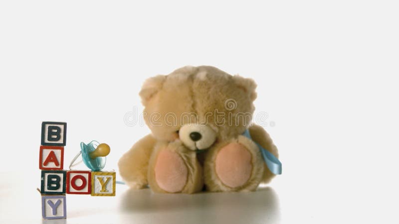 Teddy Bear Falling Besides Baby Blocks and Blue Soother Stock Video ...