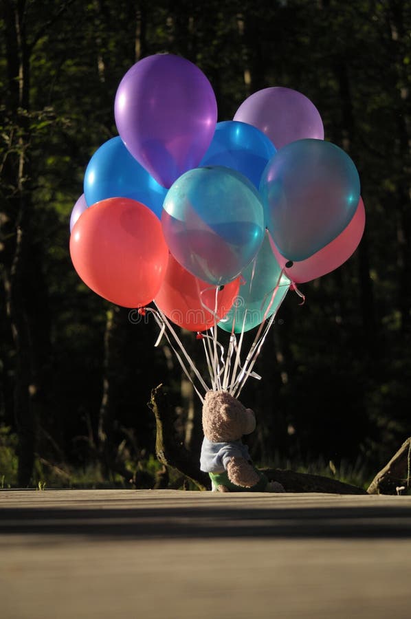 Teddy Bear Sits on a Wooden Bridge with Balloons Stock Image - Image of ...