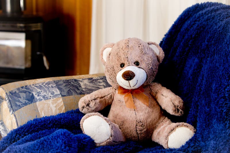 Teddy Bear - Sitting on Sofa Couch in Front of Fireplace Stock Photo ...