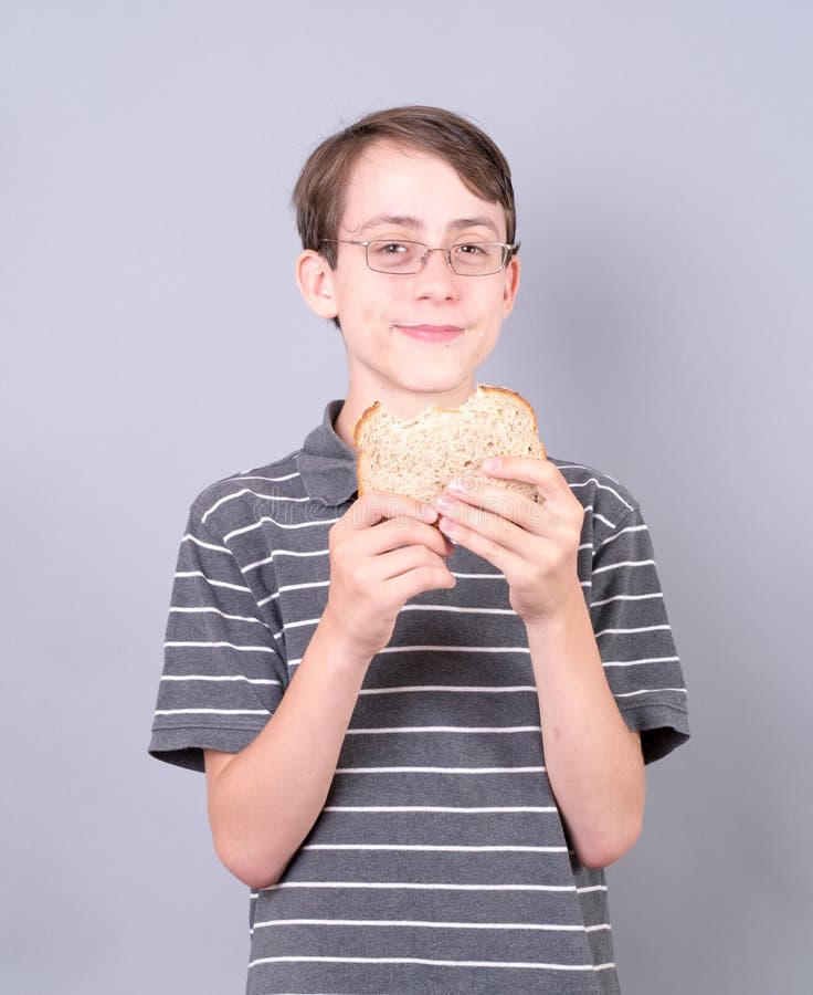 Teen Boy Eating a Sandwich stock photo. Image of snack - 25577274