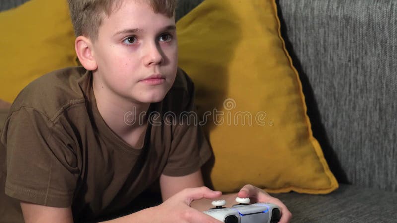 Teen Boy Focused Playing Video Games With A Portable Game Console Stock Video Video Of 2054