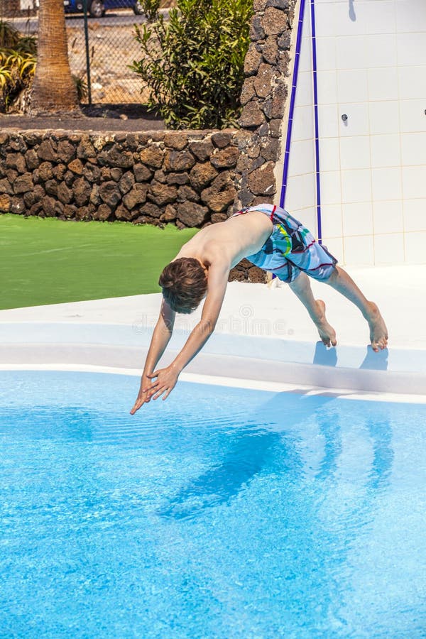 Teen Boy Jumping in the Blue Pool Stock Photo - Image of board, male ...