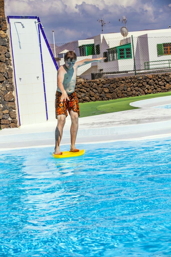 Teen Boy Jumps into the Pool with His Boogie Board Stock Image - Image ...