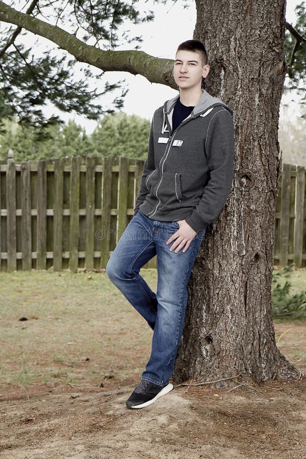 Teen Boy Leaning on Tree Outdoors Stock Photo - Image of tall, handsome ...