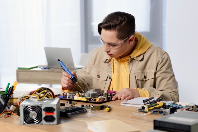 Teen Boy Soldering Computer Motherboard with Soldering Iron Stock Photo ...