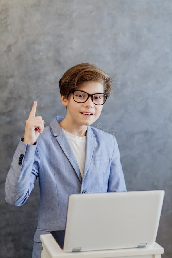 Teen Boy with Laptop Computer by Wall Stock Photo - Image of wireless ...