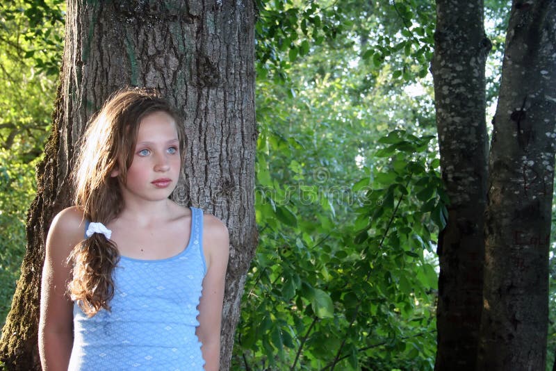 Teen Girl Leaning Against Tree Stock Image - Image of outdoors, girl ...