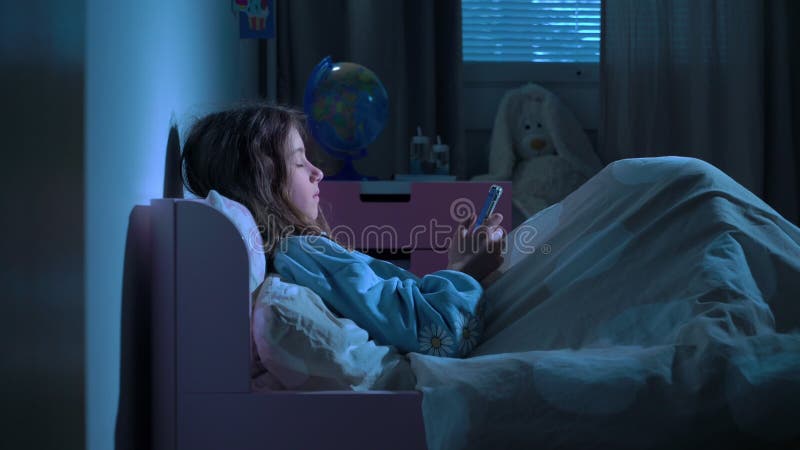 Teen Girl Lying in Bed at Night and Using Smartphone. Stock Footage ... Teen Girl Lying in Bed at Night and Using Smartphone. Stock Footage ...