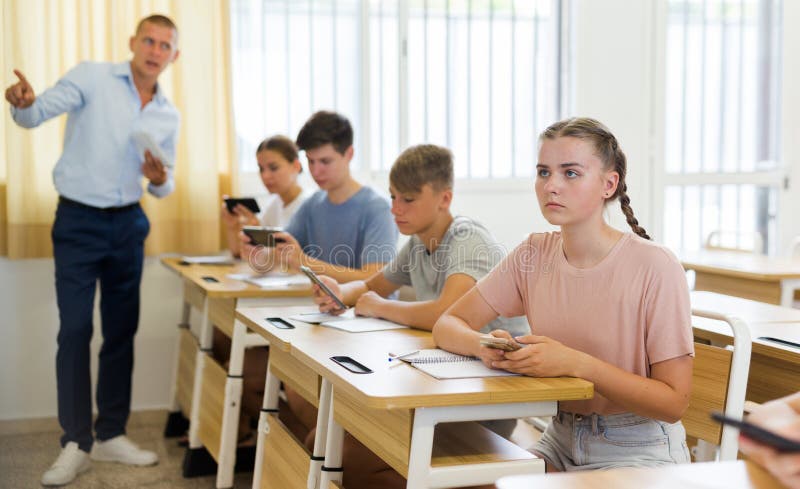 Teen Girl Student Using Smartphone while Studying in College Stock ... Teen Girl Student Using Smartphone while Studying in College Stock ...