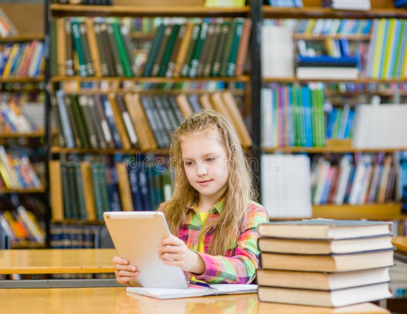 Teen Girl with Tablet Computer Working in Library Stock Photo - Image ...