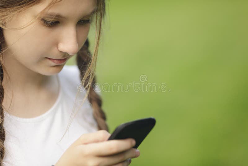 Teen Girl Using Mobile Phone Stock Image - Image of casual, pigtails ...