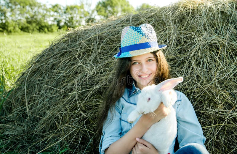 Teen Girl with White Rabbit Sitting in Front of Haystack Stock Photo ...