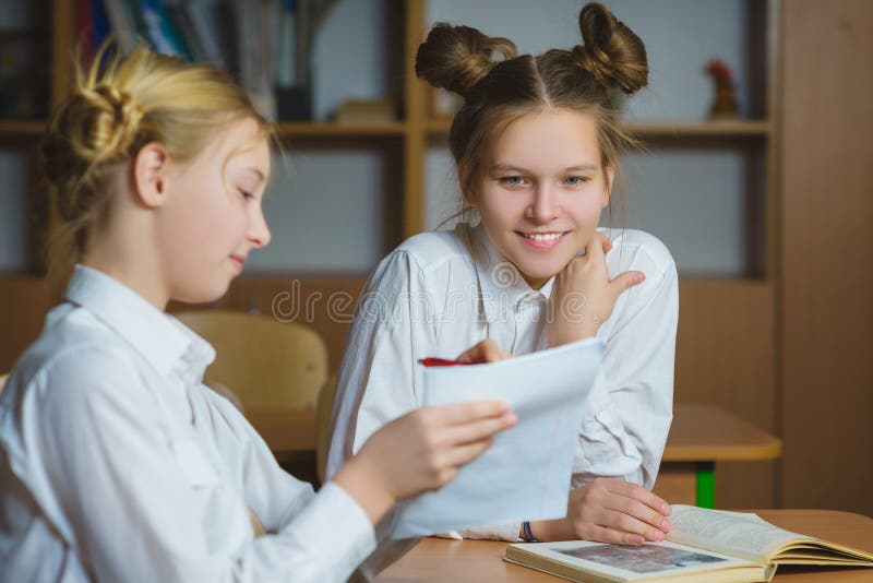 Teen Girls in the School Library or Classroom, Discussing What they are ...