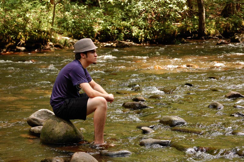 Teen Sitting on River Rocks, Side View Stock Photo - Image of rock ...