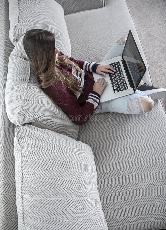 Teen Student Studying on the Couch Doing School Work from Home Stock ...