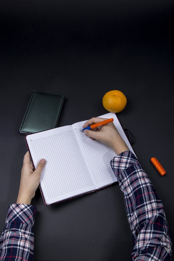 Teen Writes with a Pen in an Open Notebook on the Table Stock Photo ...