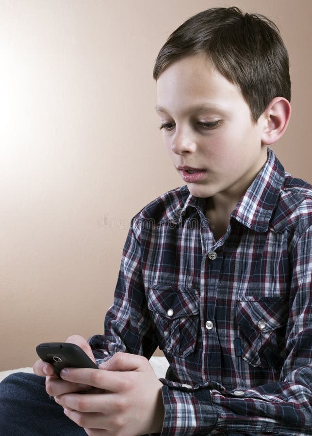 Teenage Boy with Cell Phone Stock Image - Image of cellular, looking ...