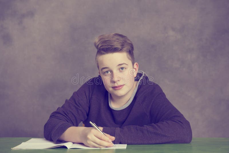 Teenage boy doing homework stock photo. Image of clever - 88688668