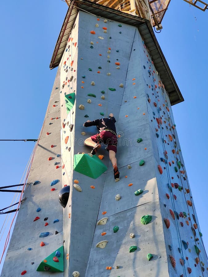 A Teenage Boy is Doing Training and Climbing a Climbing Wall on a ...