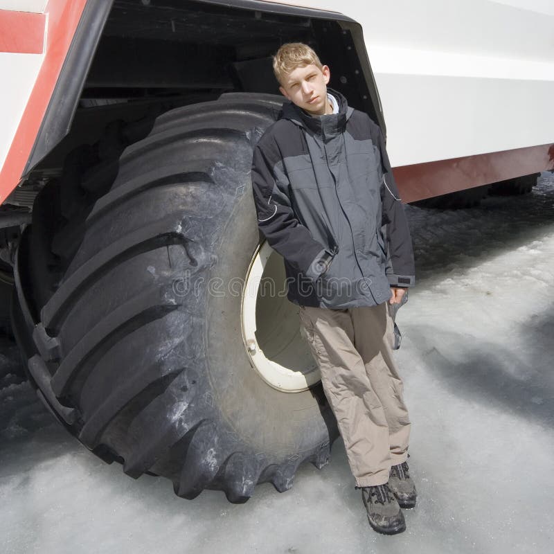 Teenage Boy in Front of a Large Tire Stock Photo - Image of square ...