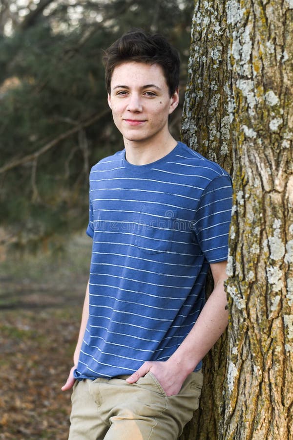 Teenage boy stock image. Image of tree, leaning, pine - 113175439