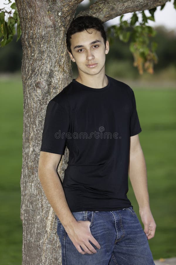 Teenage Boy Leaning Up Against a Tree. Stock Photo - Image of posing ...