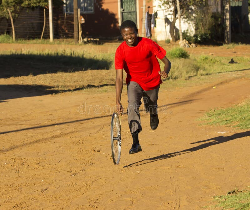 Teenage Boy Playing with Wheel Stock Image - Image of playground, sandy ...