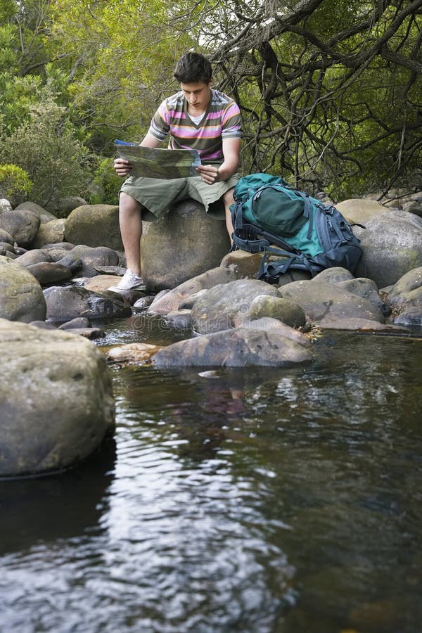 Teenage Boy Reading Map in Forest Stock Photo - Image of forest ...