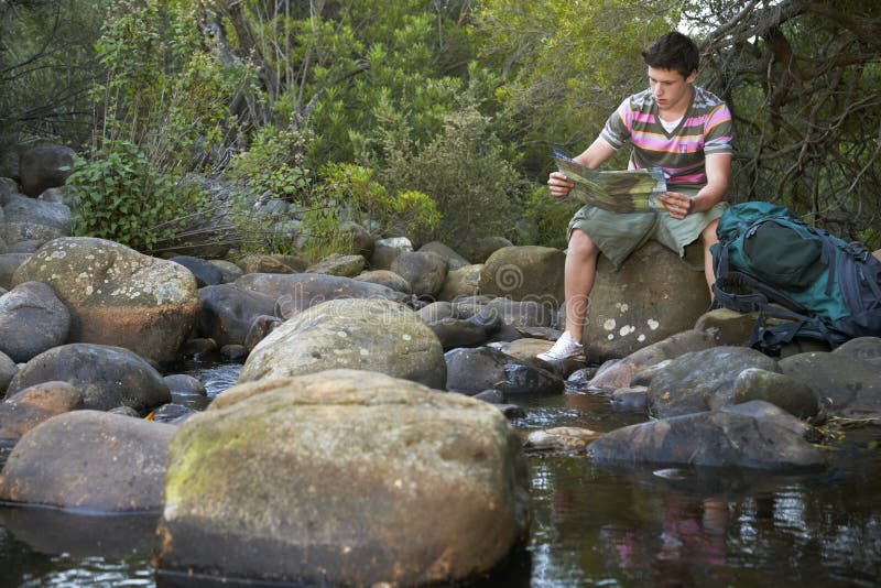 Teenage Boy Reading Map in Forest Stock Image - Image of forest ...