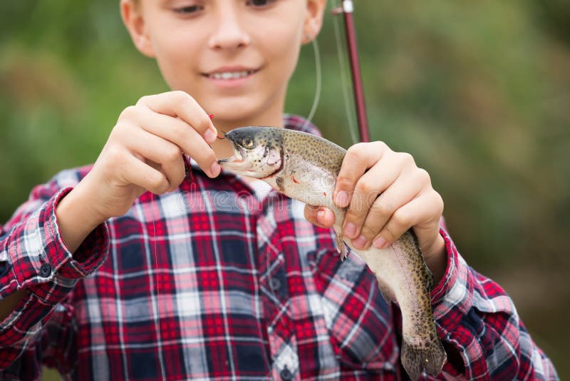 Teenage Boy Releasing Catch on Hook Fish Stock Photo - Image of crucian ...