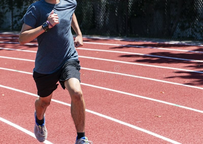 Teenage Boy Running Clockwise on a Red Track Stock Image - Image of ...