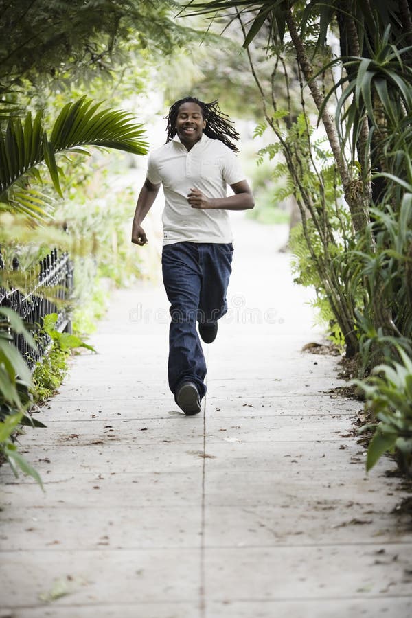 Teenage Boy Running on Sidewalk Stock Photo - Image of enjoyment ...