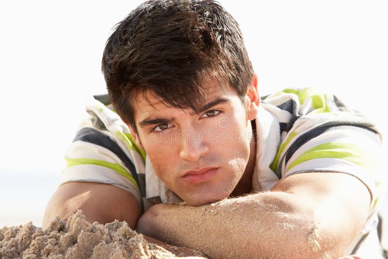 Teenage Boy Sitting on Beach Stock Photo - Image of teenage, sport ...