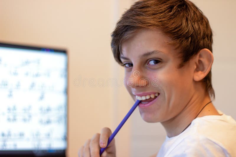 A Teenage Boy Solves Mathematical Problems at the Computer. the Student ...