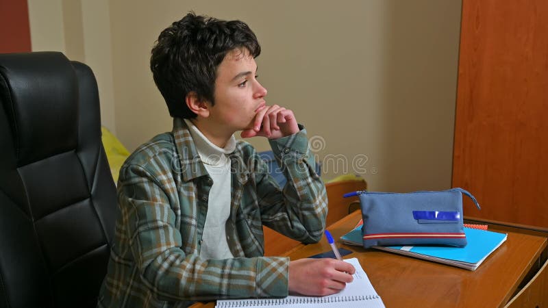 Teenage Boy Studying at Desk Writing Notes in Journal Stock Video ...