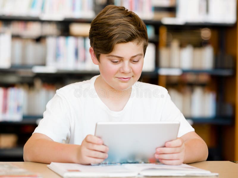 Teenage Boy with Tablet in Library Stock Photo - Image of male, books ...