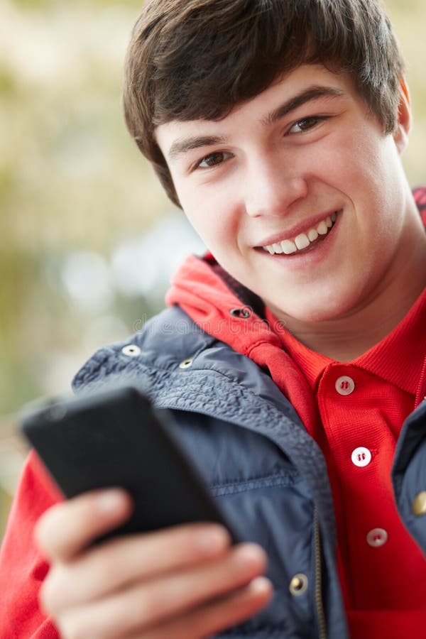 Teenage Boy Texting on Smartphone Stock Photo - Image of male ...