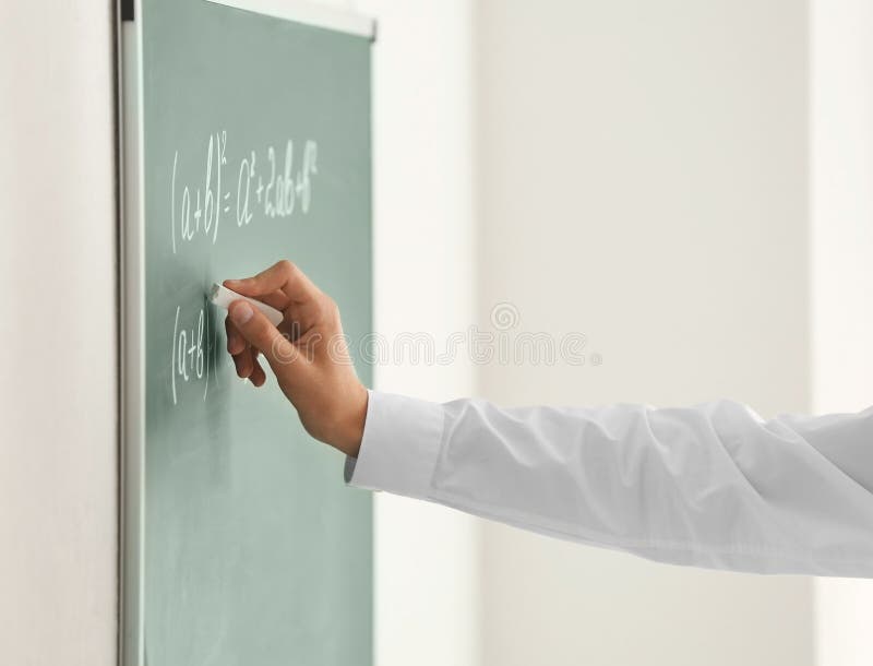 Teenage Boy Writing on Chalkboard in Classroom Stock Image - Image of ...