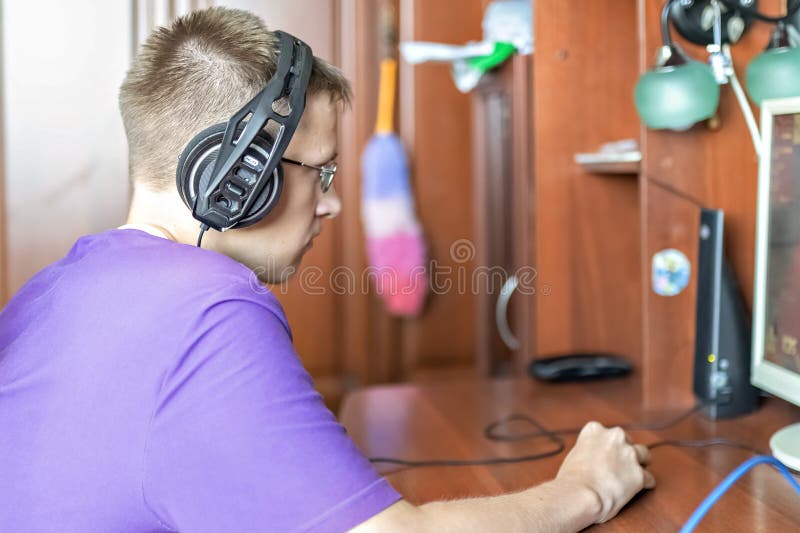 A Teenage Boy, a Young Man Playing Video Games on a Computer, Using ...