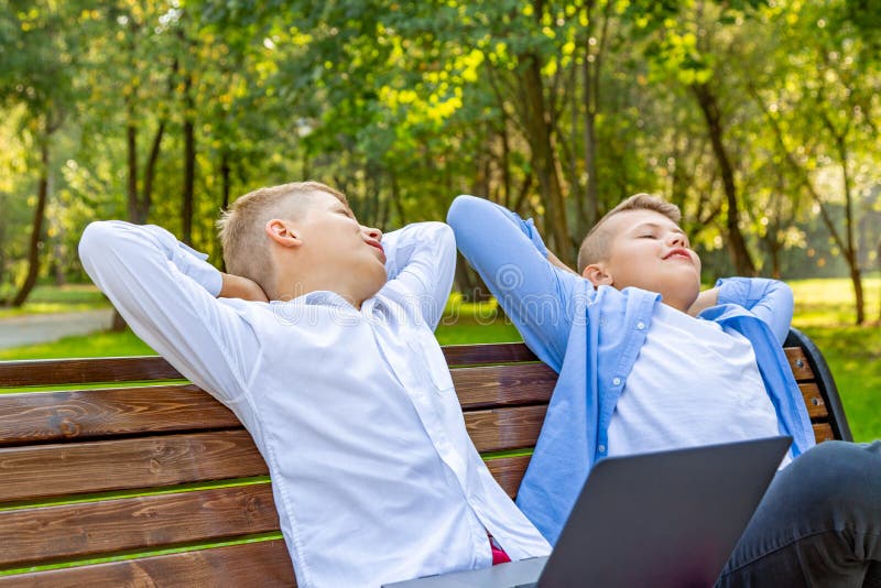 Teenage Boys on Park Bench Have Fun and Relax Stock Photo - Image of ...