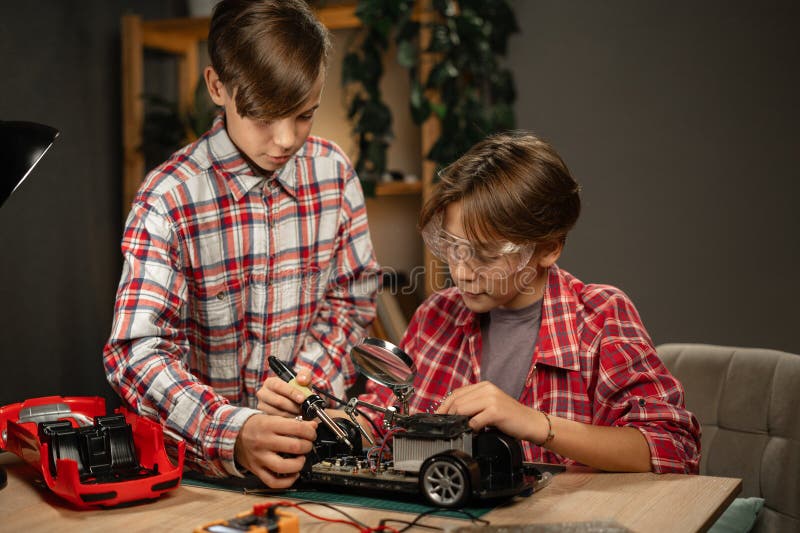 Teenage Brothers Studying Electronics Making a Car on the Remote ...
