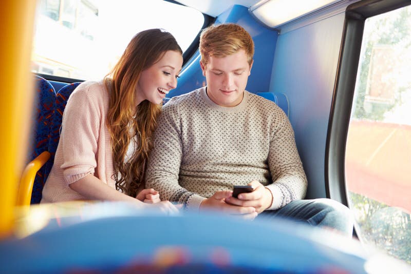Teenage Couple Reading Text Message on Bus Stock Image - Image of ...