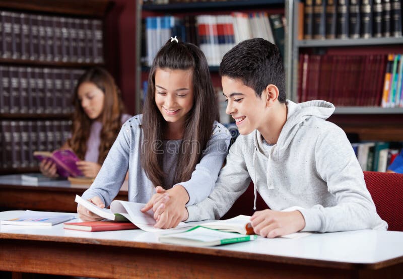Teenage Couple Studying Together in Library Stock Photo - Image of ...