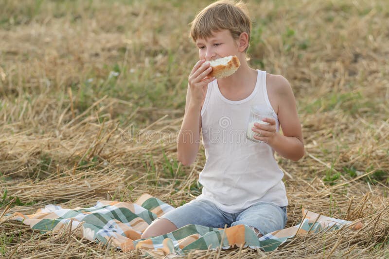 Teenage Farmer Boy Eating Fresh White Bread Stock Image - Image of ...